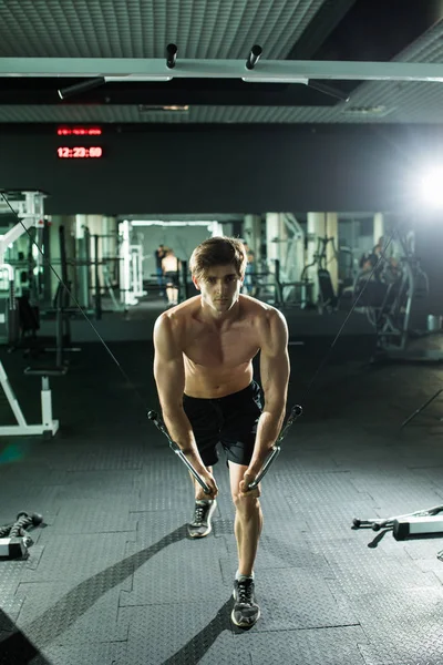 Man doing step up jumps in health club. The man is exercising his legs ...