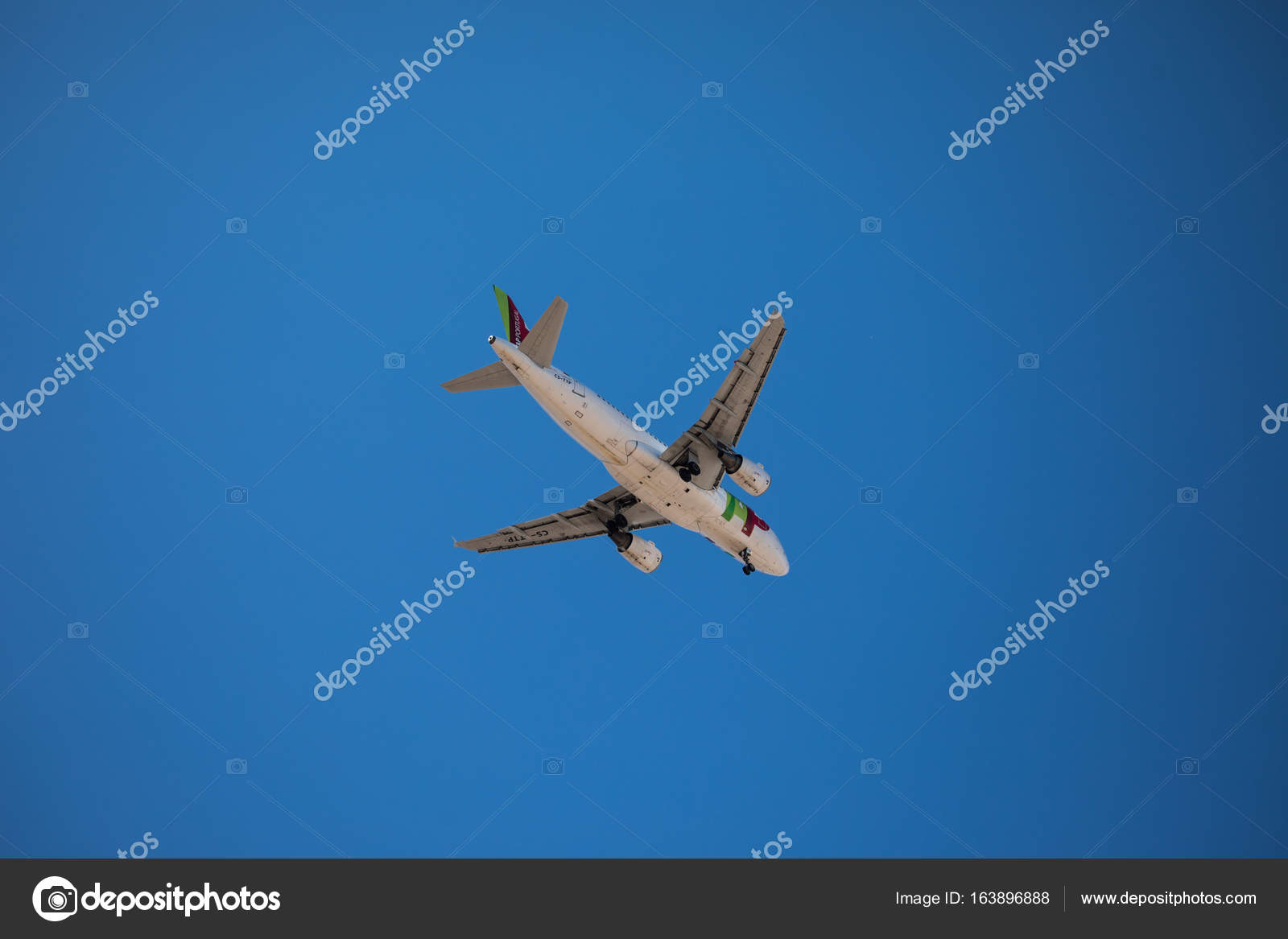 A Passenger plane is flying in the clear blue sky. Passenger airplane ...