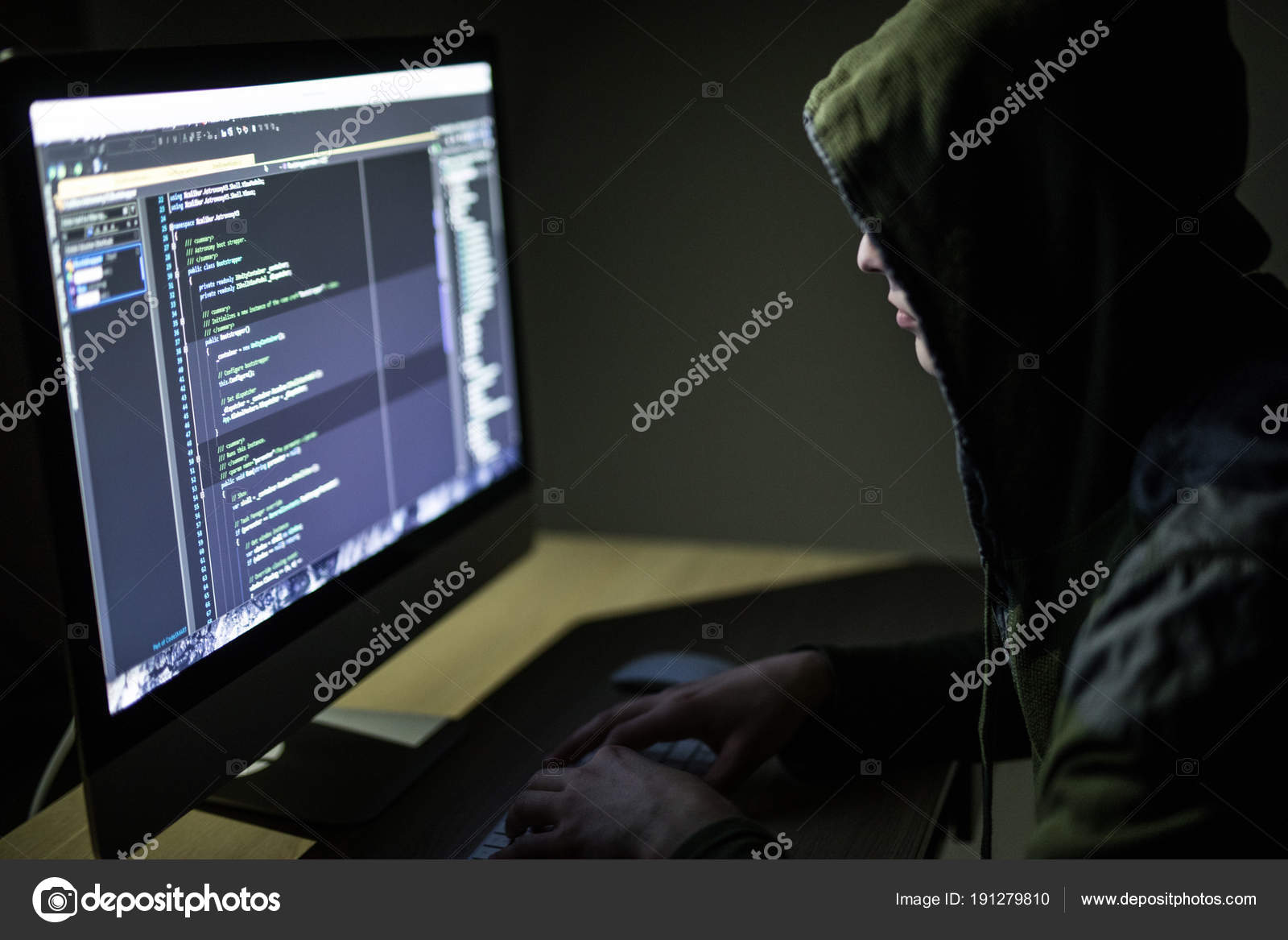Computer hacker in hood working in dark room code on pc and hack ...