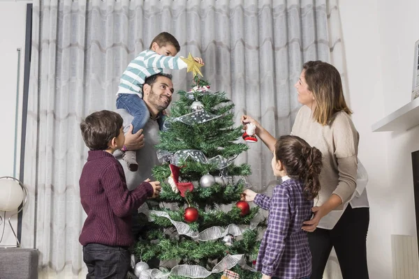 Family decorating Christmas tree - Stock Image - Everypixel