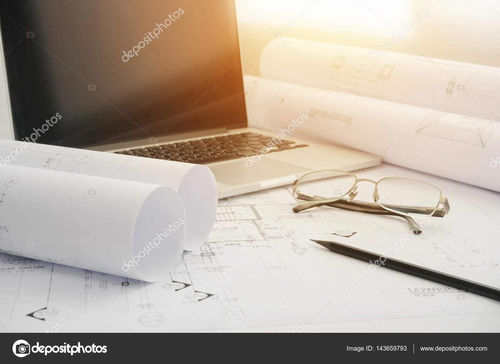 Black pencil and computer laptop on architectural drawing paper for ...