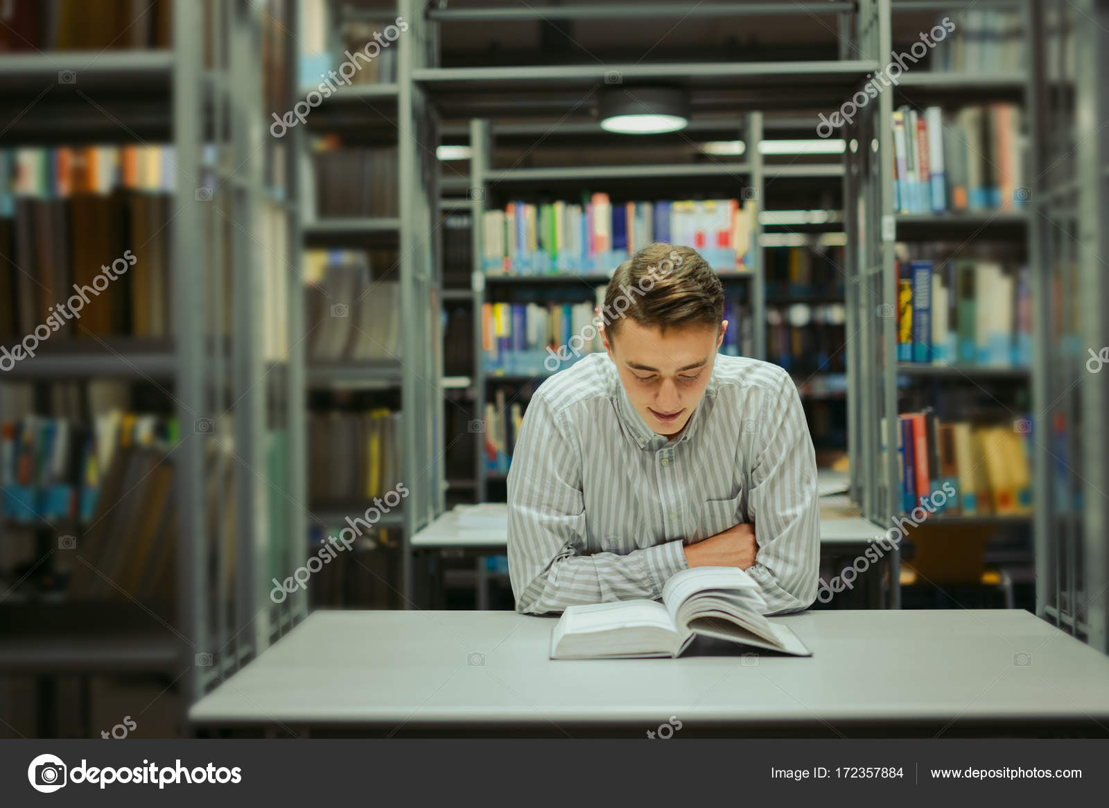 Man sit on the library and read book with blur background — Stock Photo ...