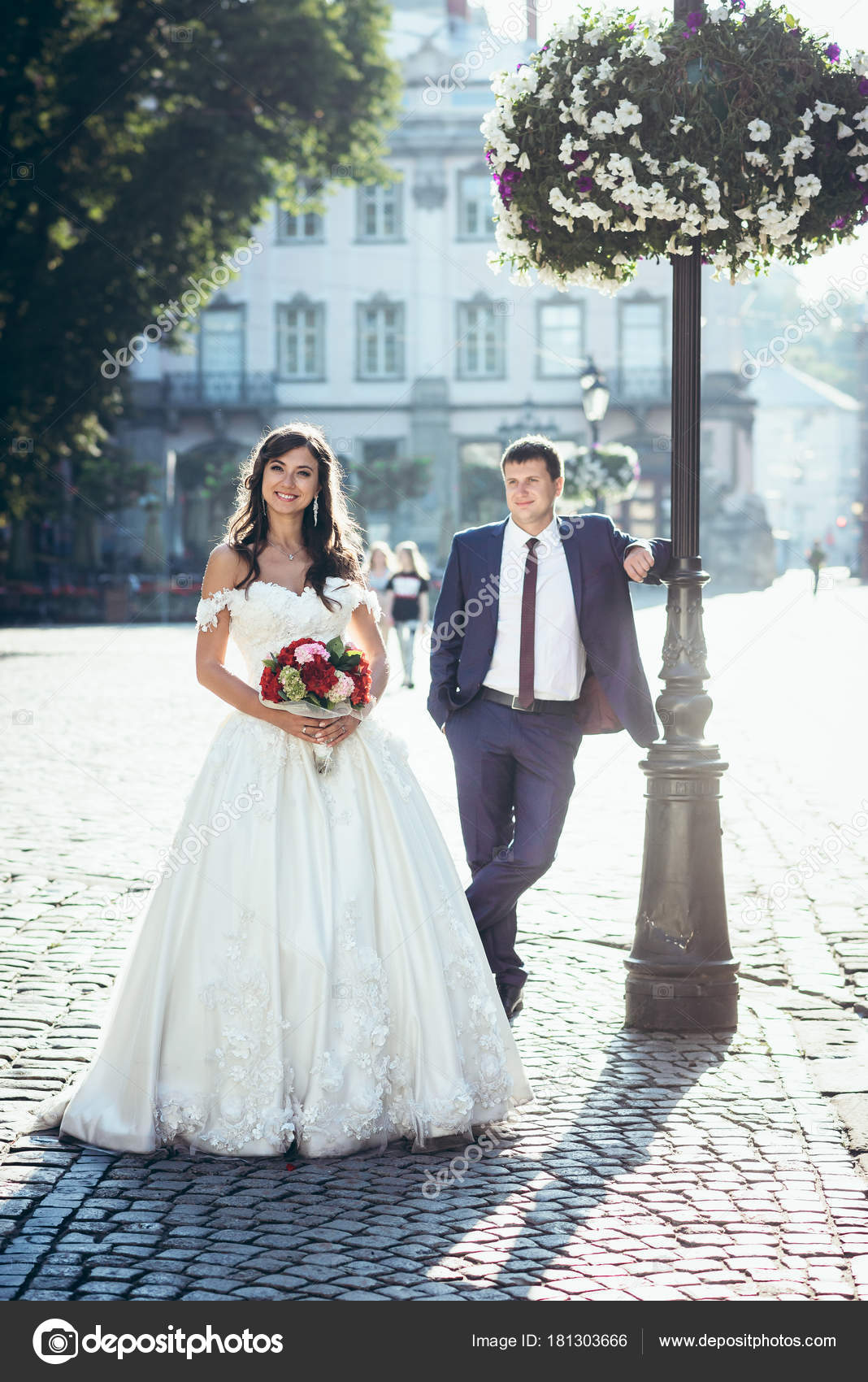 Full-length outdoor wedding portrait. The beautiful brunette bride with ...