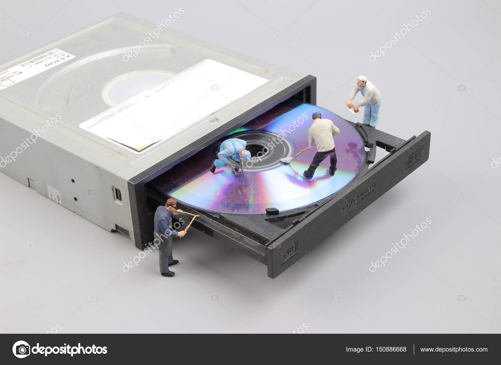 Miniature engineer and worker fixed to clean CD rom — Stock Editorial ...