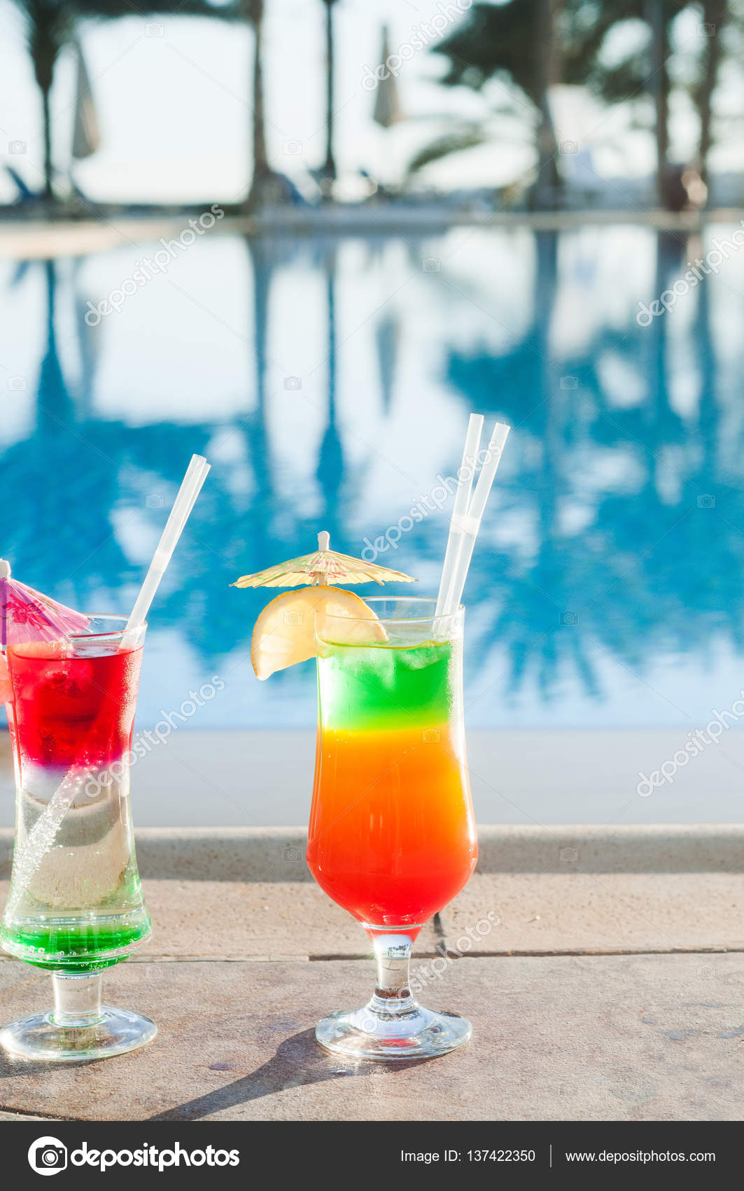 Colored cocktails on a background of water. Colorful cocktails near the ...