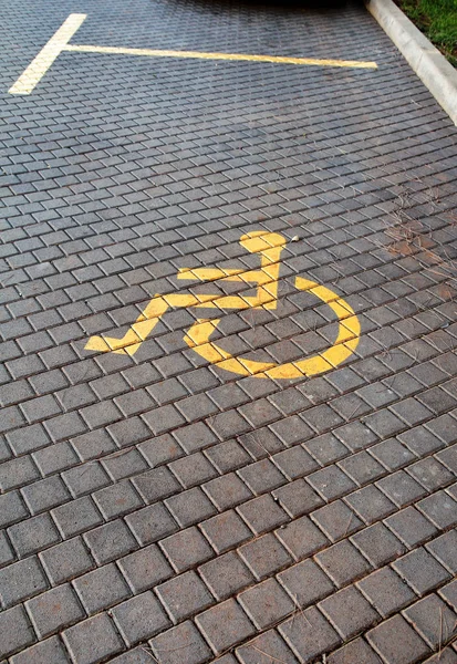 Post with disabled parking space and sign in front of parking bay in ...
