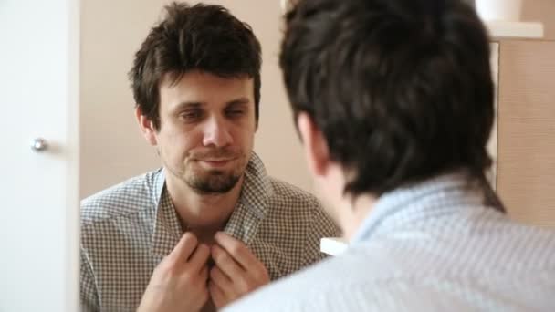 Tired sleepy man who has just woken up brush his teeth, looks at his ...