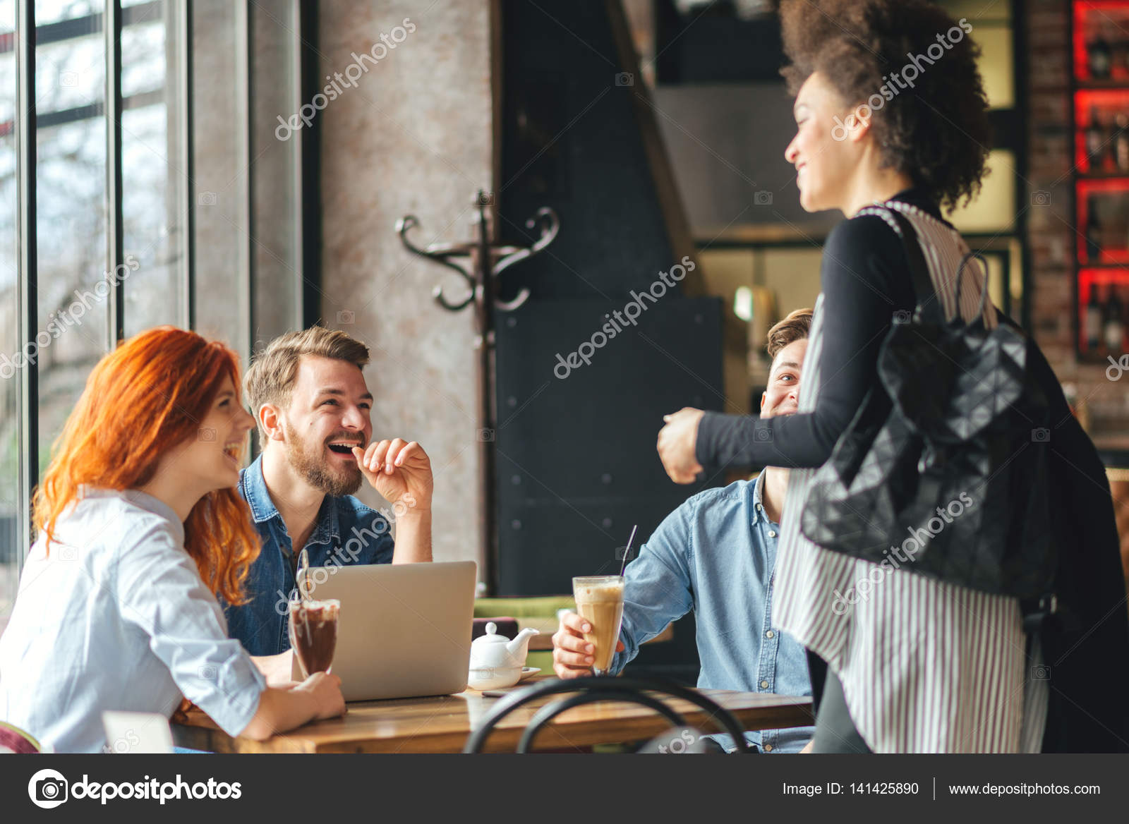 Friends having a great time in the cafe. Stock Photo by ©SerbBgd 141425890