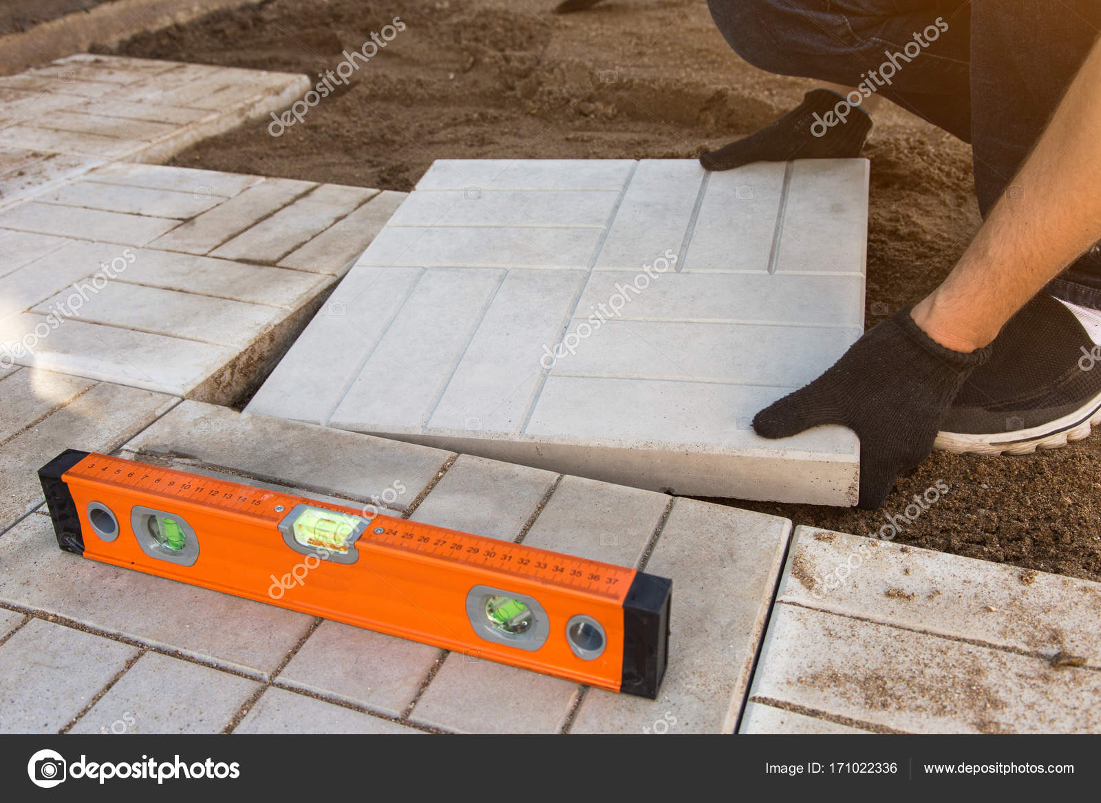 Building level on the background of work on laying paving slabs Stock ...