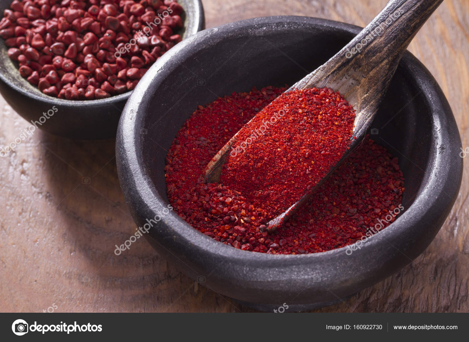 Achiote grains and powder in wooden bowl Stock Photo by ©CUNDO 160922730