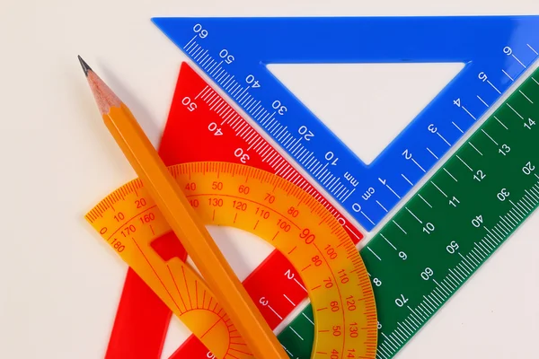 Drawing angles with set squares, pen, notebook and paper on plywood ...