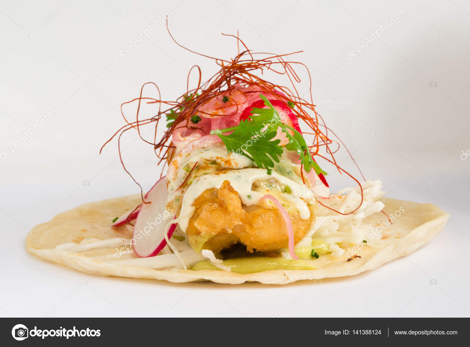 Golden fried cod fish taco isolated on a white background, served with ...