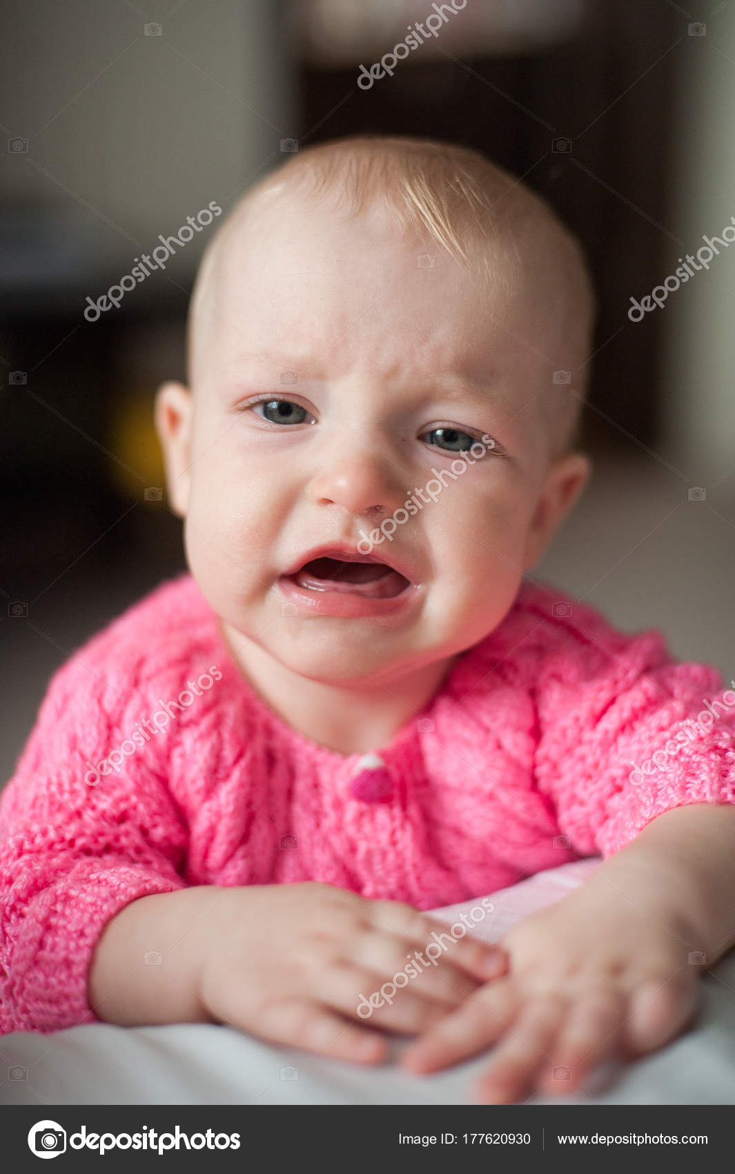 Cute crying baby, upset teething girl. Sad child look at the camera ...