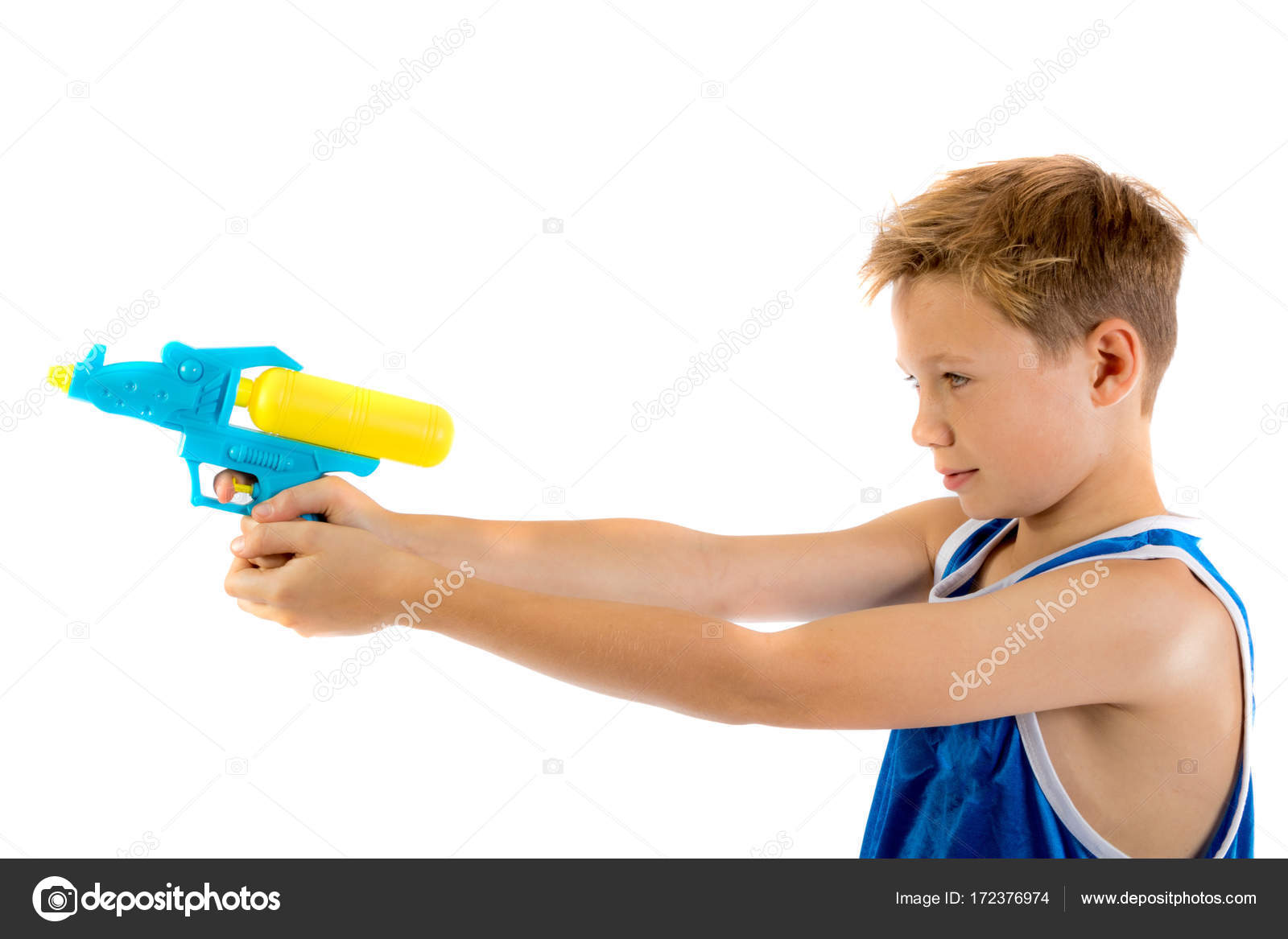 Pre-teen boy playing with water guns Stock Photo by ©Triumph0828 172376974