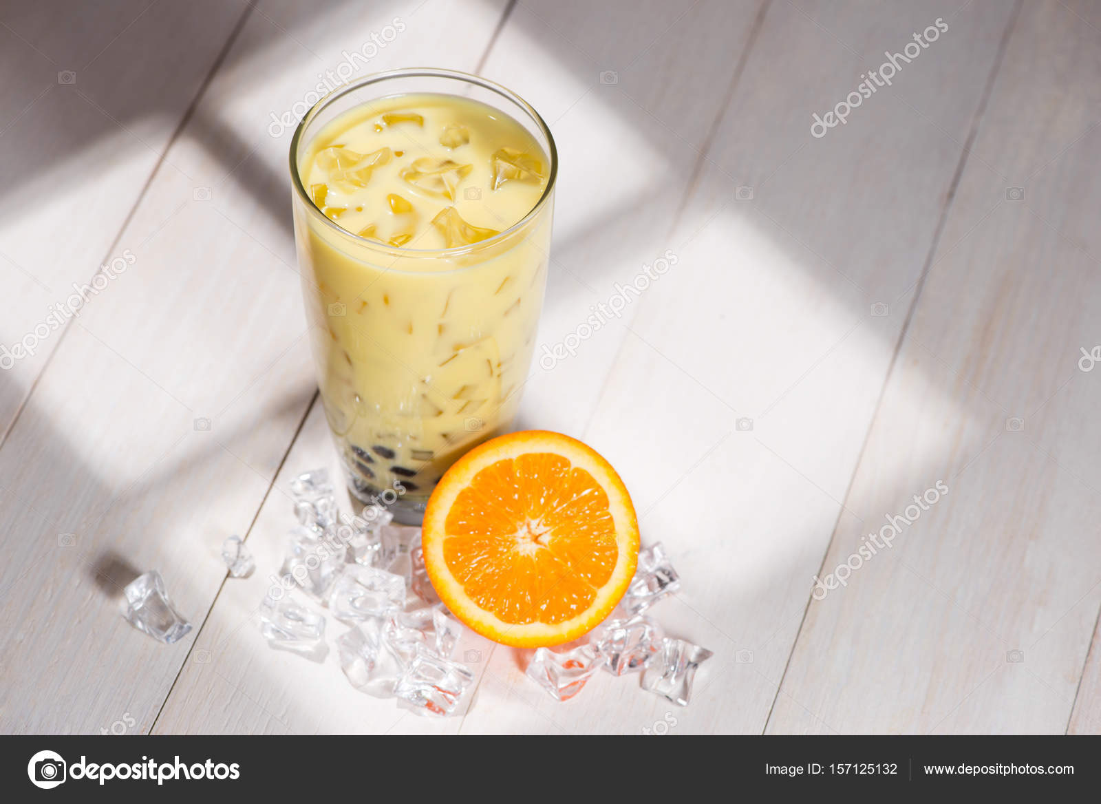 Milk tea with ice cubes Stock Photo by ©makidotvn 157125132