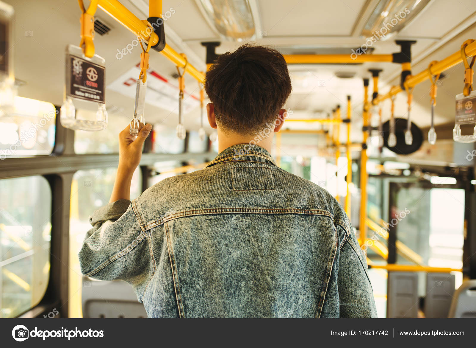 Man standing inside bus. Stock Photo by ©makidotvn 170217742
