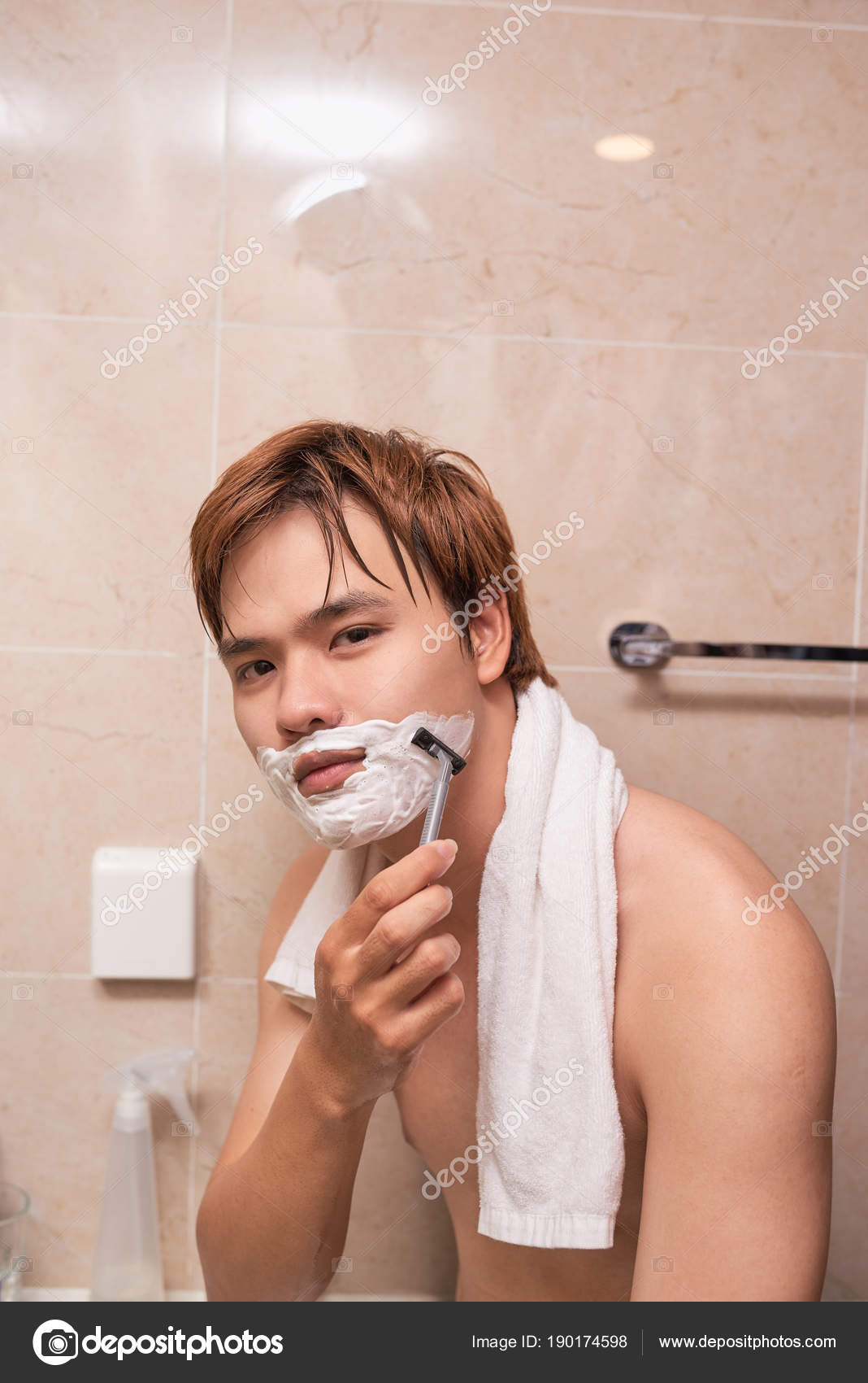 Handsome Young Asian Man Shaving His Face Looking Mirror — Stock Photo © makidotvn #190174598