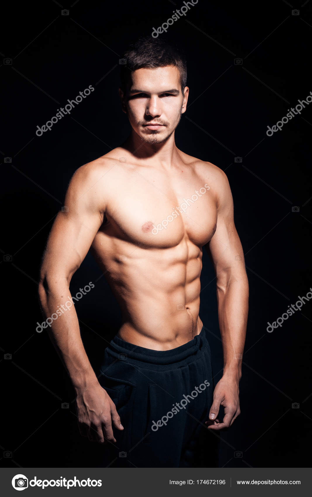 Young handsome man with perfect torso on black background; — Stock ...