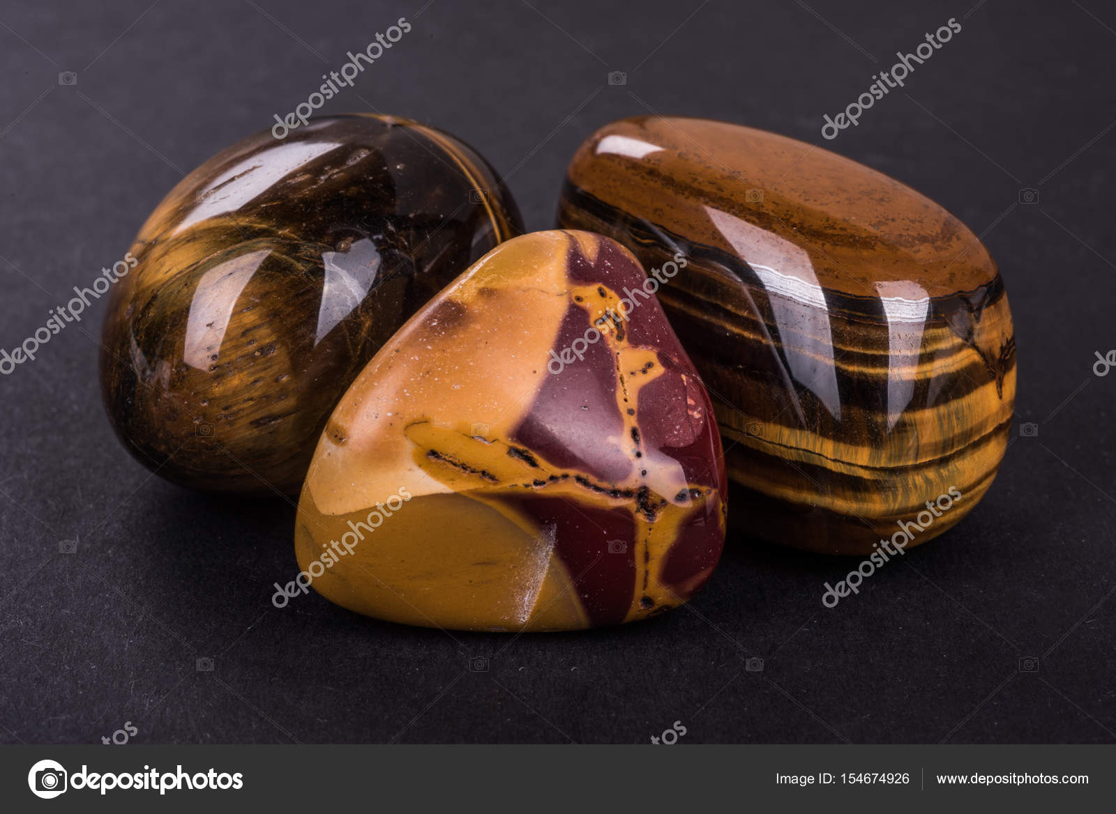 Tiger Eye geode on black background — Stock Photo © ZlataMarka #154674926