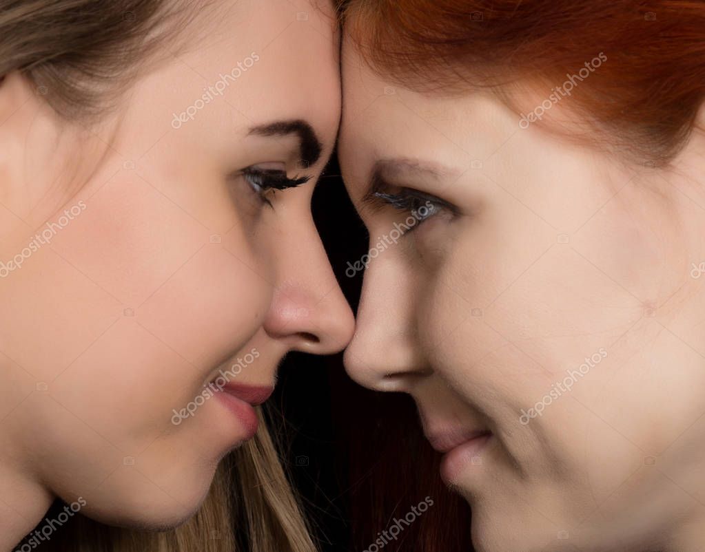 Two Pretty Lesbians Girlfriends Kissing And Hugging In A Cozy