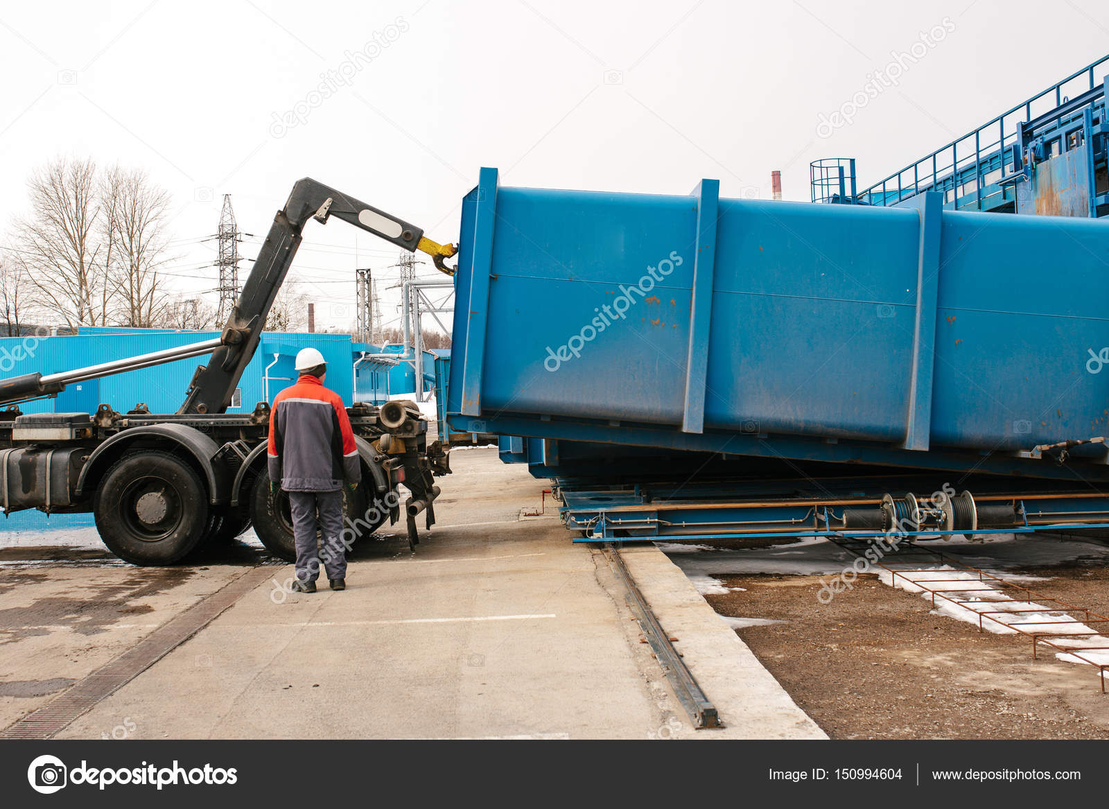 Loading container with waste to a special machine for subsequent ...
