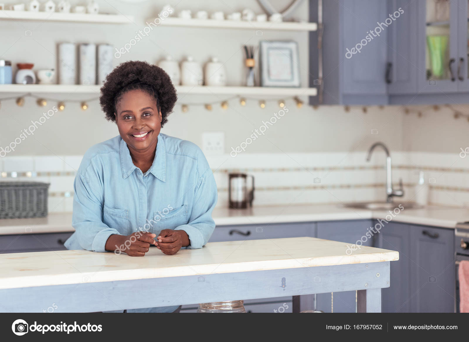 Woman leaning on kitchen counter Stock Photo by ©mavoimages 167957052