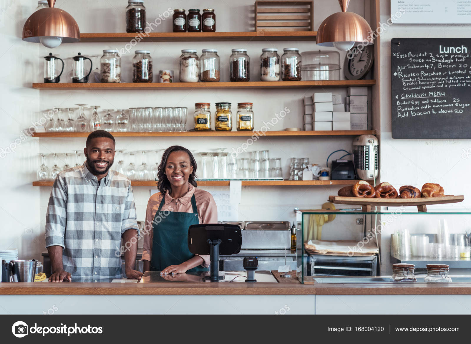 Entrepreneurs standing behind counter of shop Stock Photo by ...