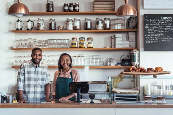 entrepreneurs standing behind counter of shop - Stock Image - Everypixel