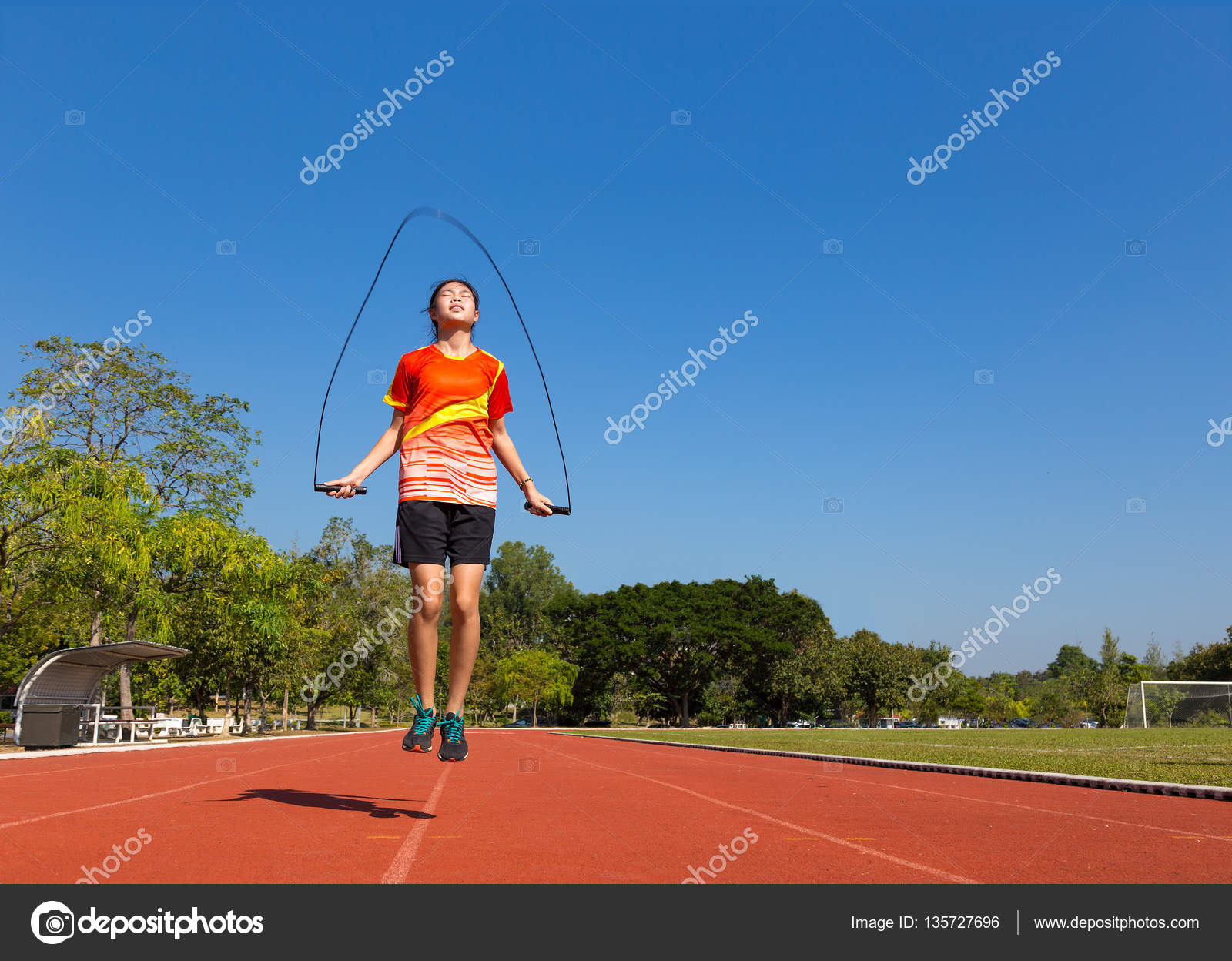Young female asian athlete rope jumping at football, soccer, fie Stock ...