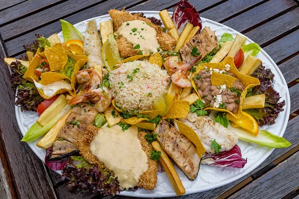 Seafood platter Plato pescado mixto. Different kinds of fish, sauce ...
