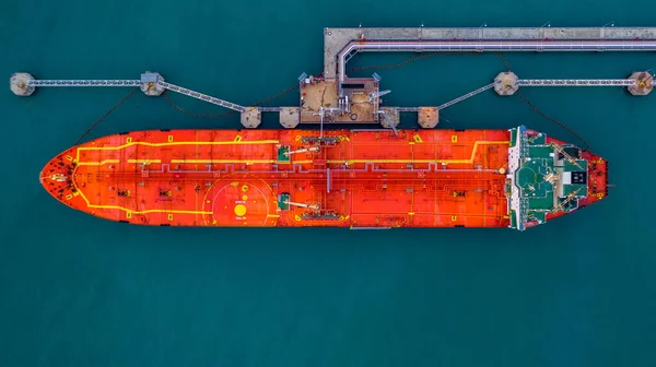 Aerial view red cargo tanker ship vessel at port with marine loading ...