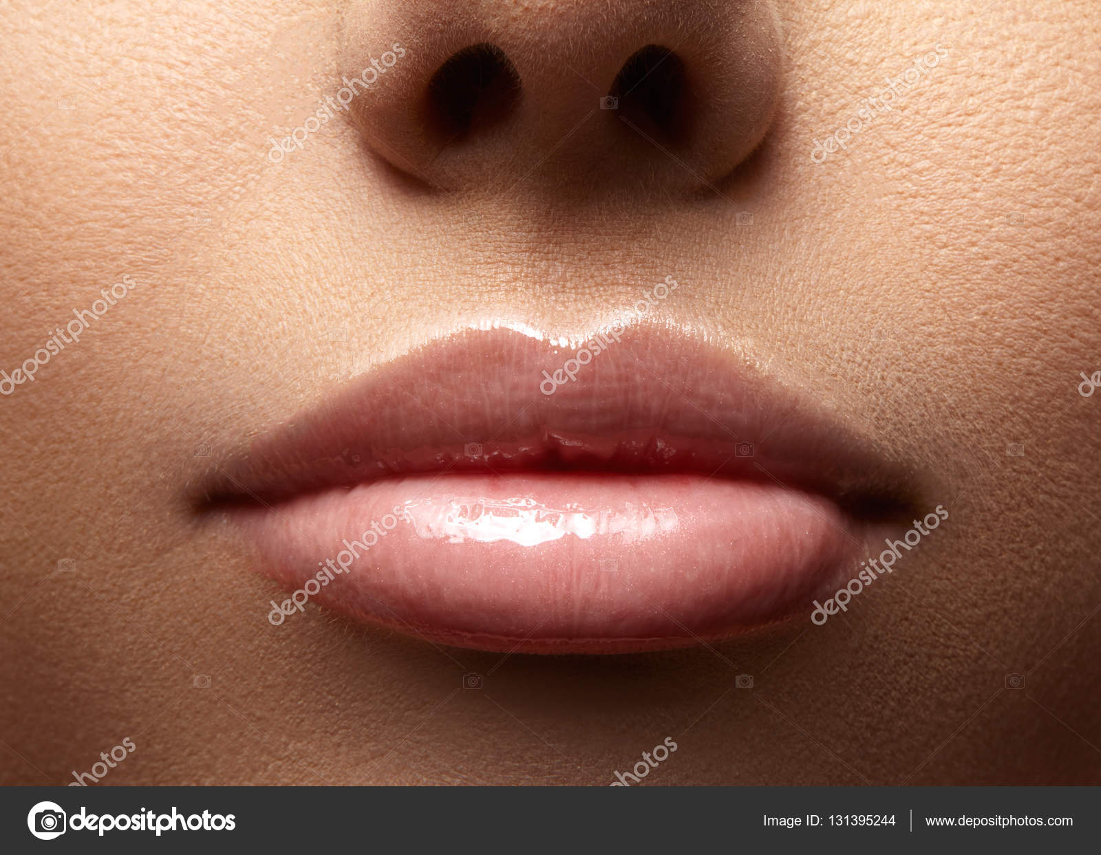 Close-up beautiful female lips with bright lipgloss makeup. Perfect ...