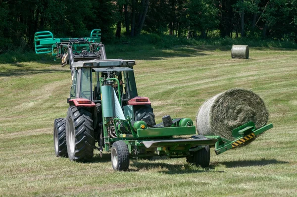 Tractor collecting haystack in the field — Stock Photo © rihardzz #6212366
