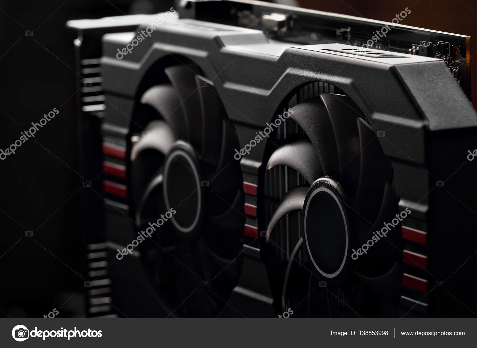 Video card with two coolers from the computer on a dark background ...