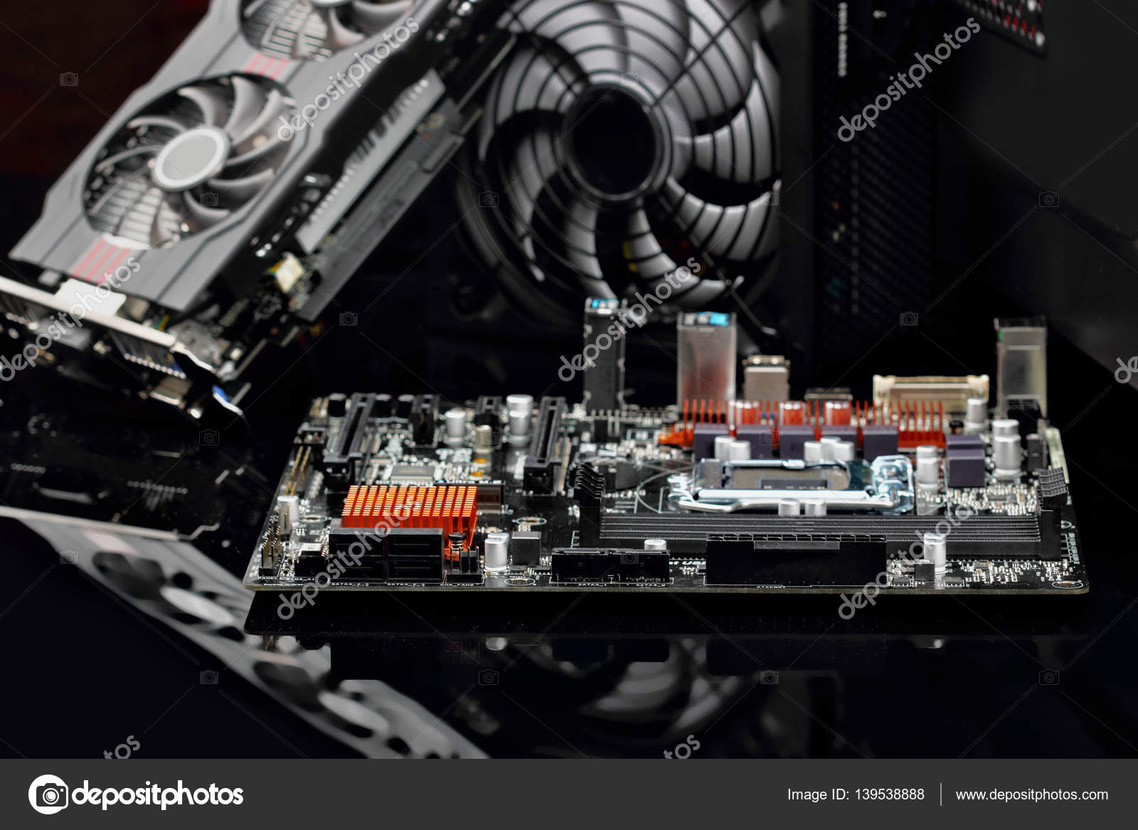Motherboard on black background videocard and power supply on second ...