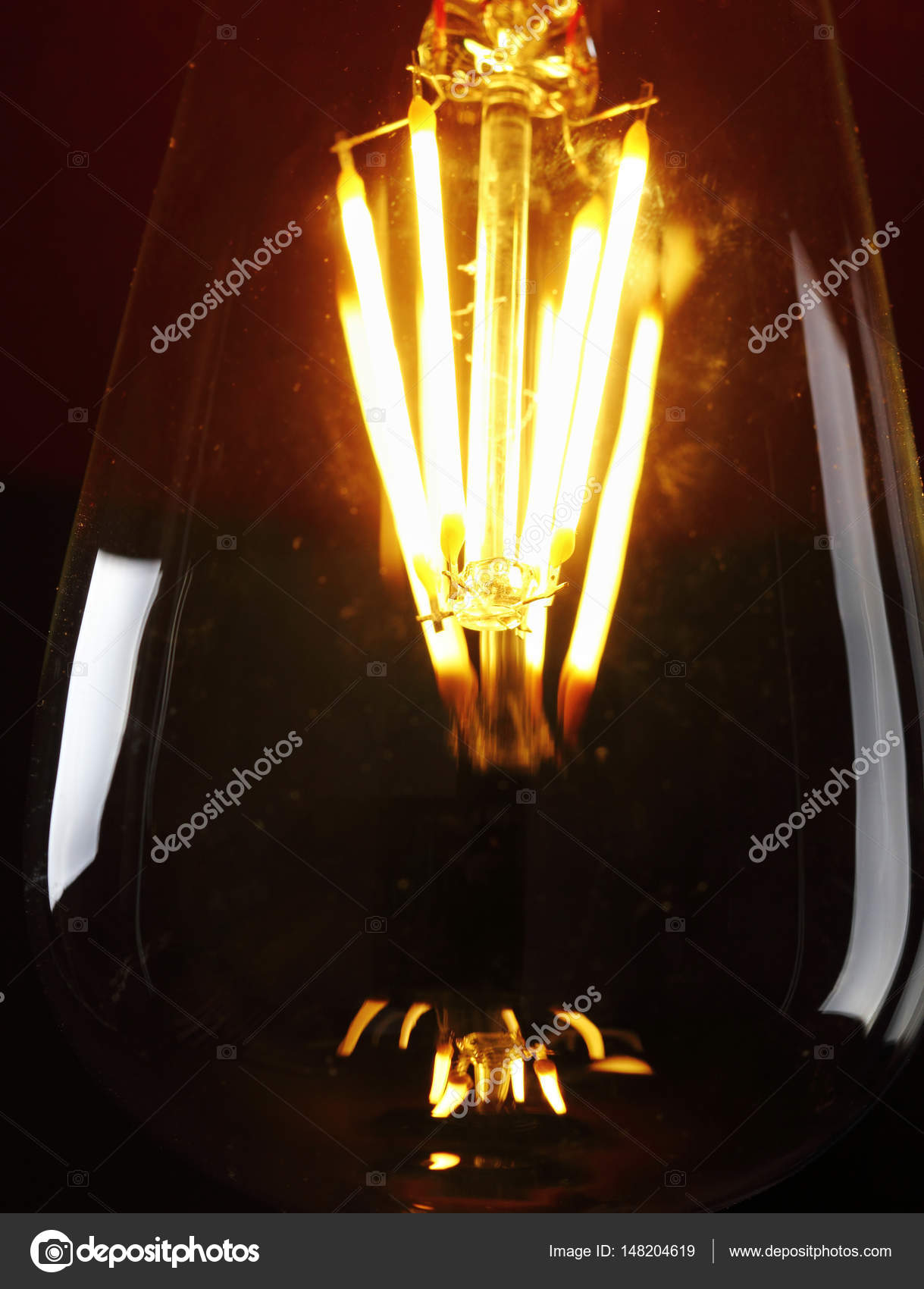 Red light bulb close-up glowing on a red elegant background - beautiful ...