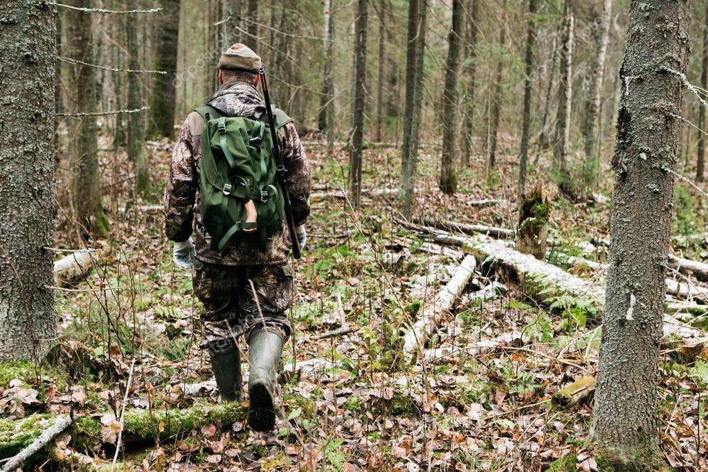 Hunter walking in the woods — Stock Photo © Scharfsinn #130357770