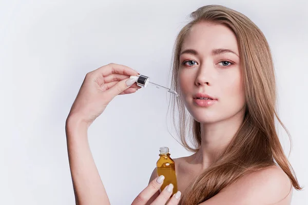 beautiful model applying a skin serum treatment on white. Spa, skincare ...