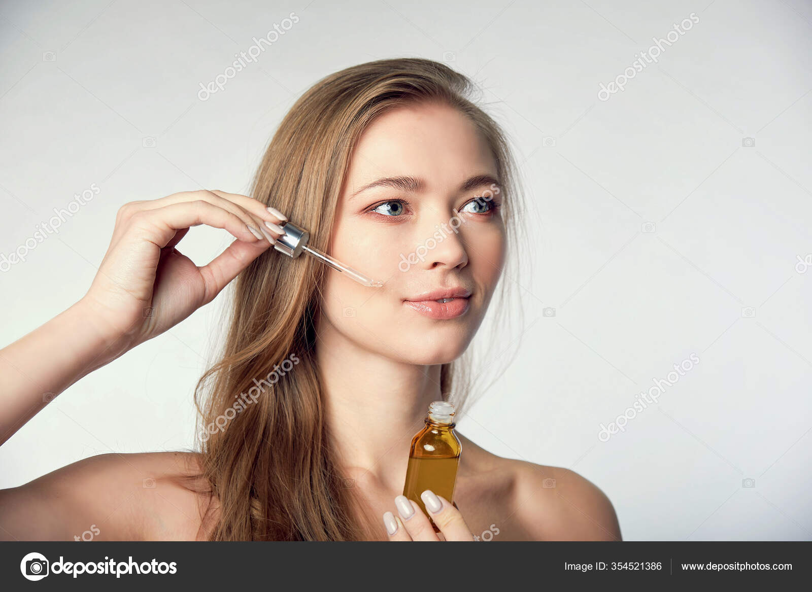 Beautiful model applying a skin serum treatment on white. Spa, skincare ...