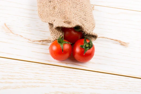 Little canvas sack and red ripe tasty fresh cherry tomatos - Stock ...