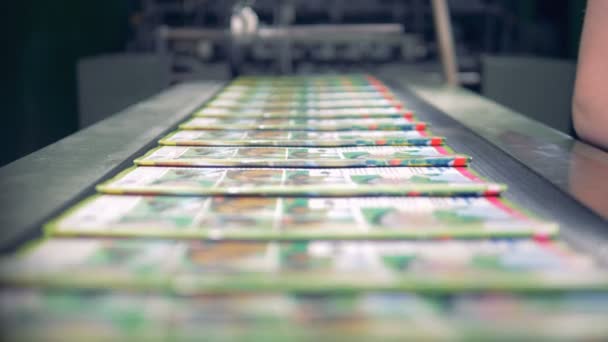 A part of journals coming out from a factory machine is getting ...