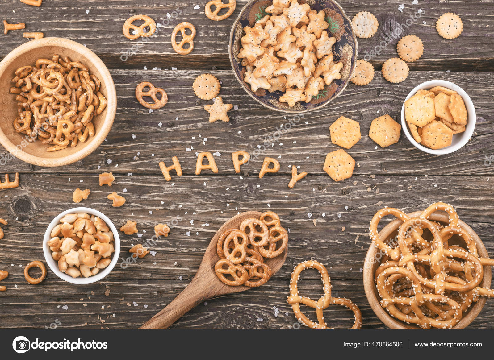 Word happy written with crackers letters on wooden background. Salty ...