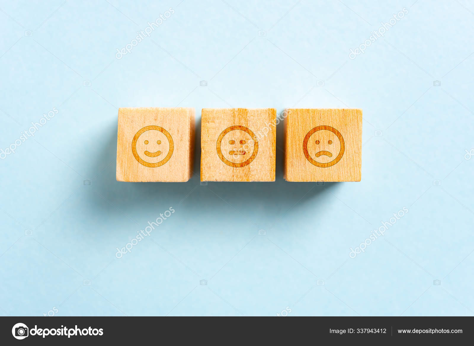 Happy, neutral and frown face on wood blocks toys and blue backg ...