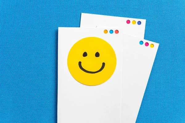 Notes with yellow circle happy smiling face cartoon on paper scr ...