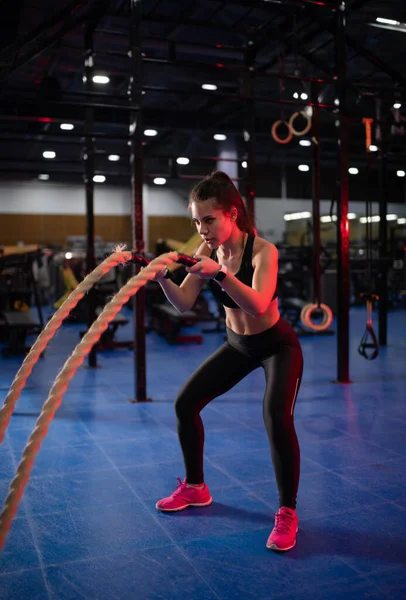 Full body strong female athlete in sportswear doing exercise with ...