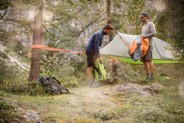 men preparing hanging tent camping near forest woods - Stock Image ...
