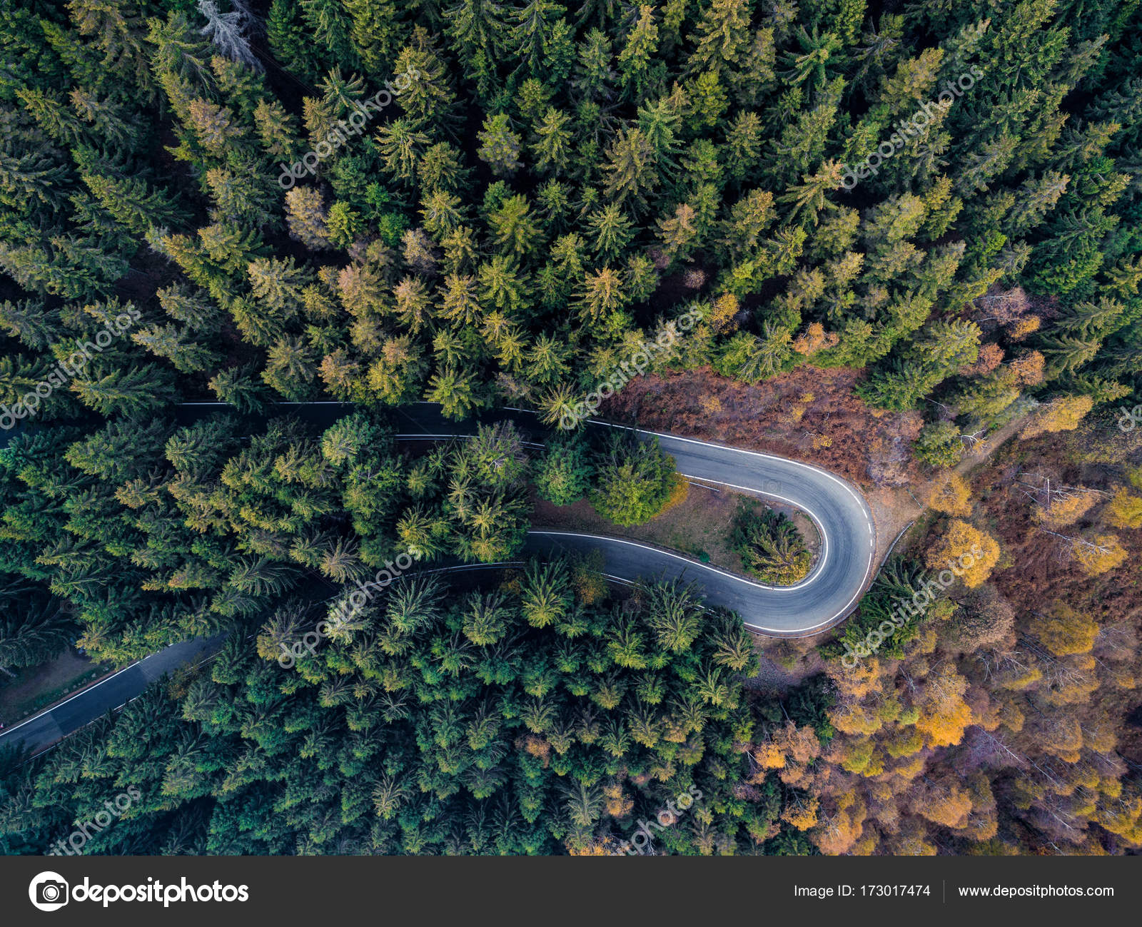 Overhead aerial top view over hairpin turn road bend in countryside ...