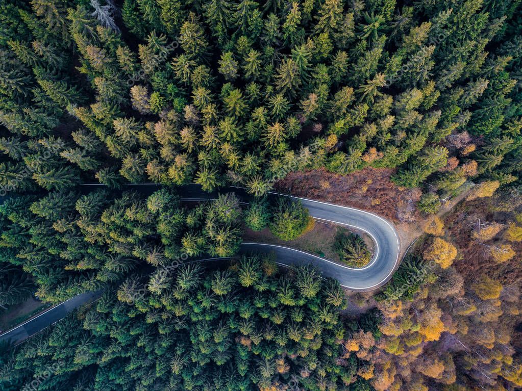 Overhead aerial top view over hairpin turn road bend in countryside ...