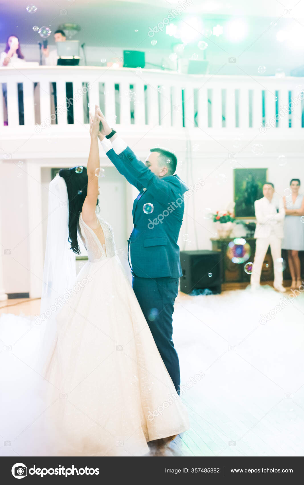 Beautiful wedding couple just married and dancing their first dance ...
