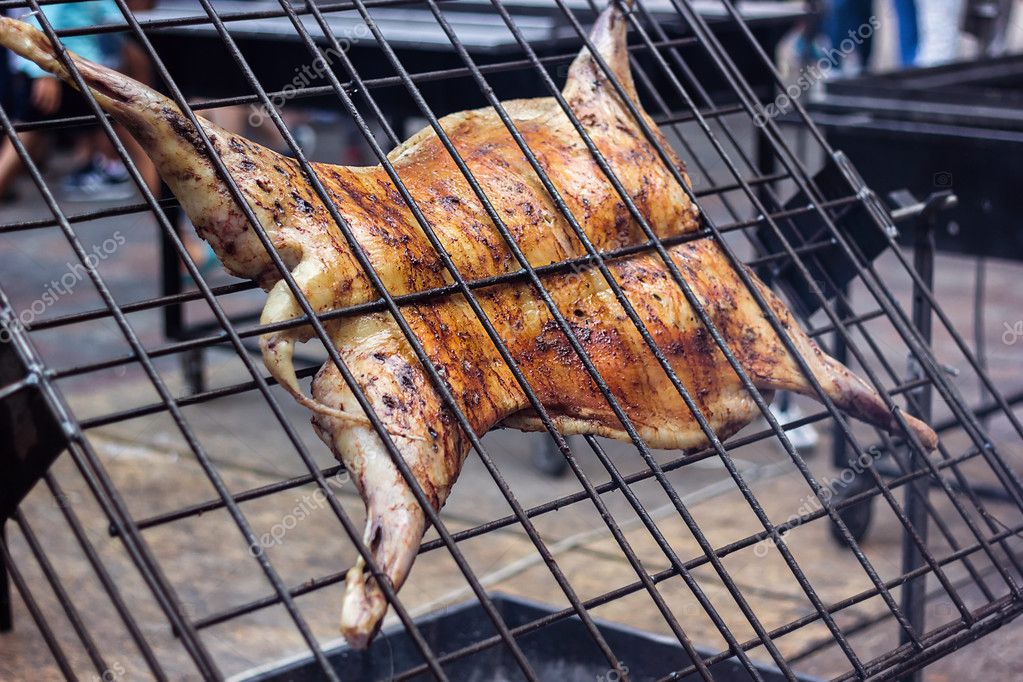 Appetizing grilled lamb on the spit. Roasted pig on traditional ...